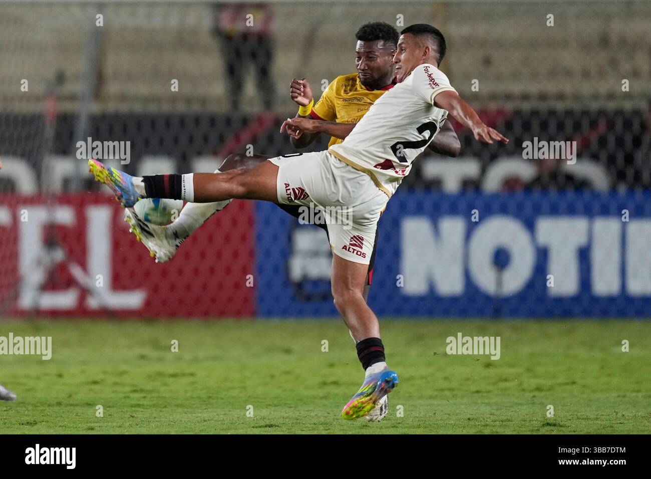 Alex Valera of Peru's Universitario de Deportes, front, and Exon ...