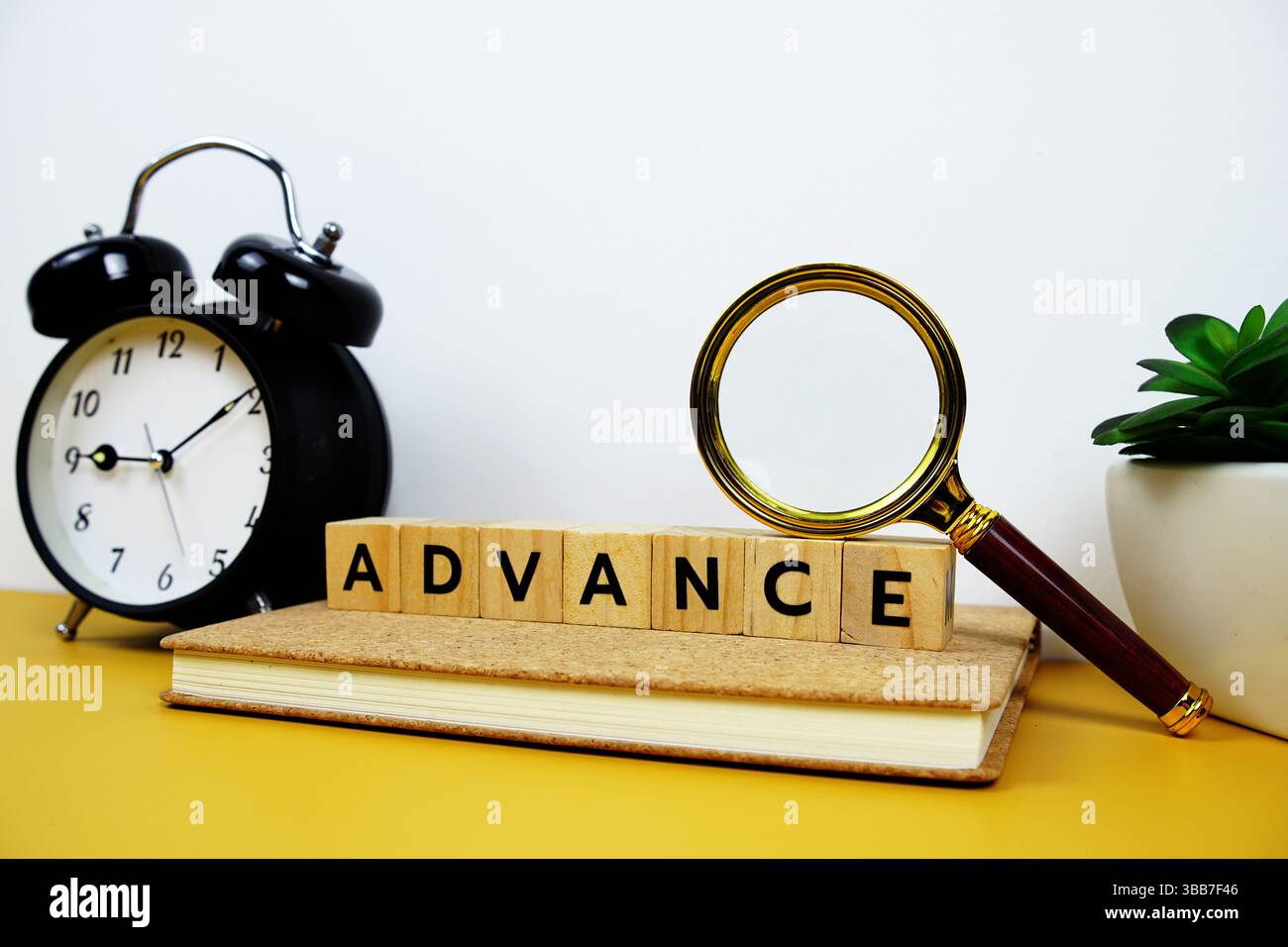 Magnifying glass and alarm clock with wooden blocks alphabet letters ...