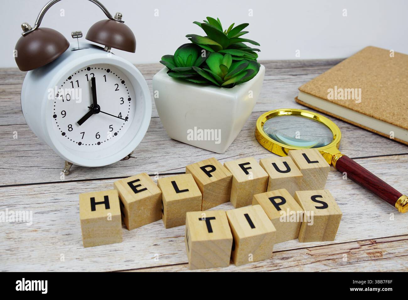 Magnifying glass and alarm clock with wooden blocks alphabet letters ...