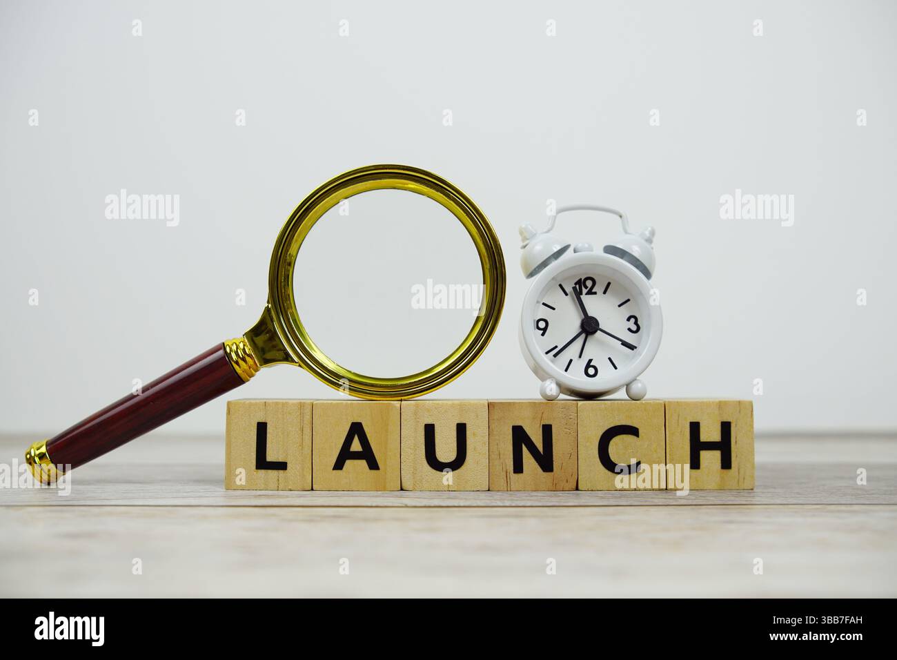 Time to Launch with wooden blocks alphabet letters and Magnifying glass ...