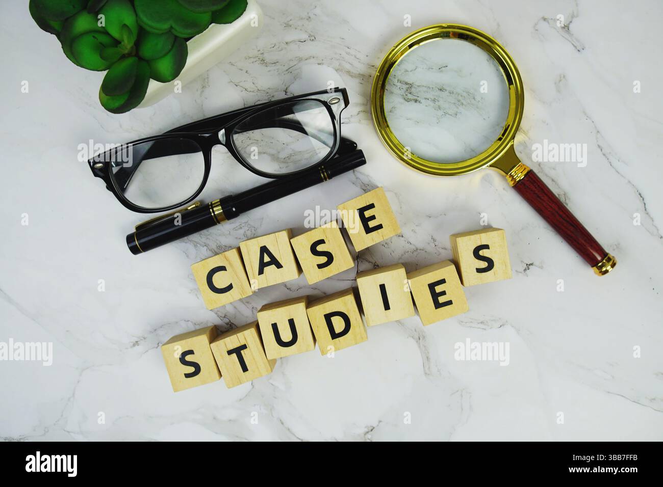 Case Studies with wooden blocks alphabet letters and Magnifying glass ...