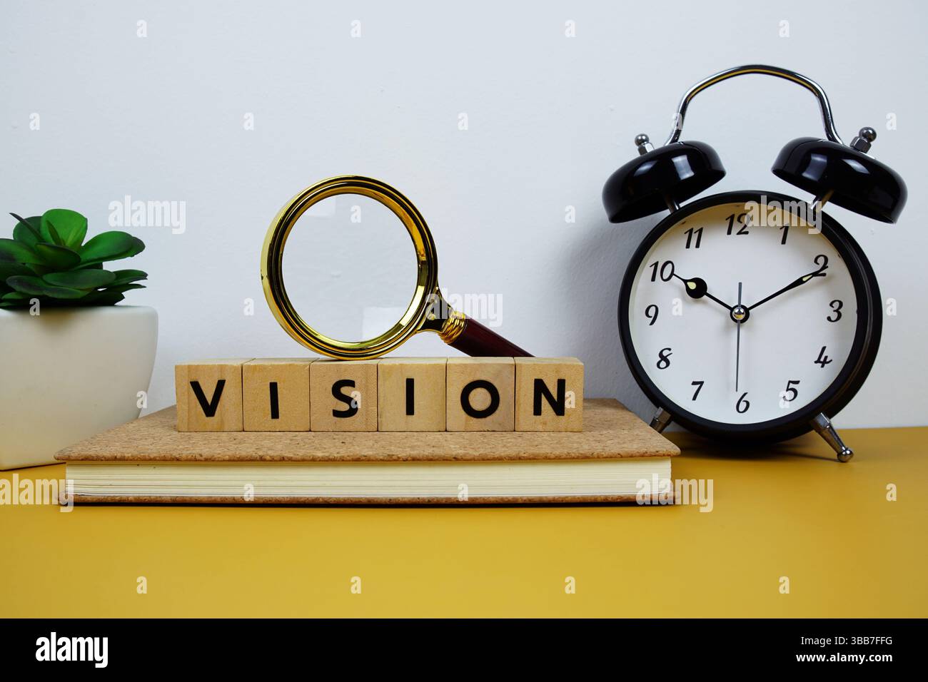 Magnifying glass and alarm clock with wooden blocks alphabet letters ...