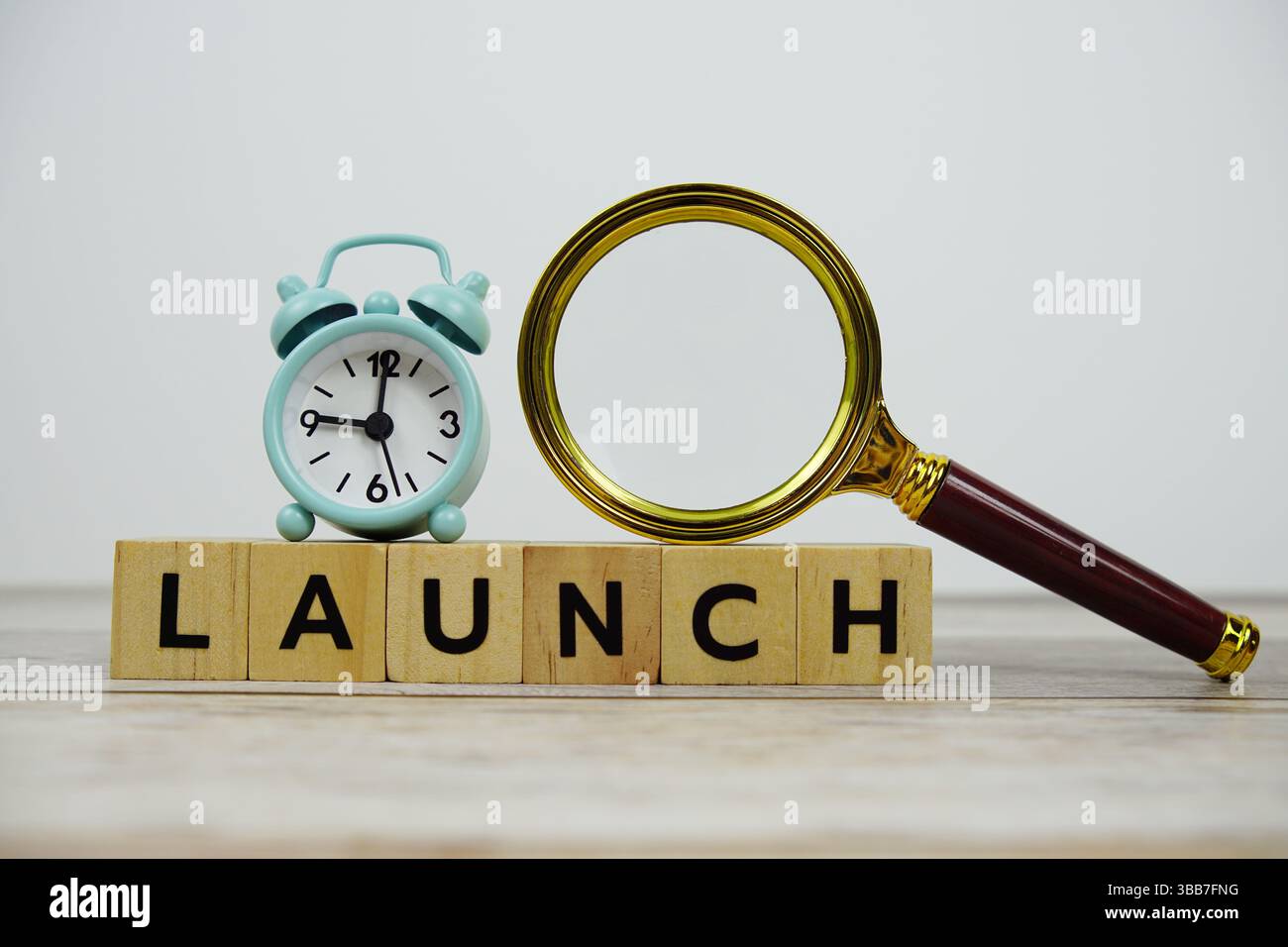 Time to Launch with wooden blocks alphabet letters and Magnifying glass ...