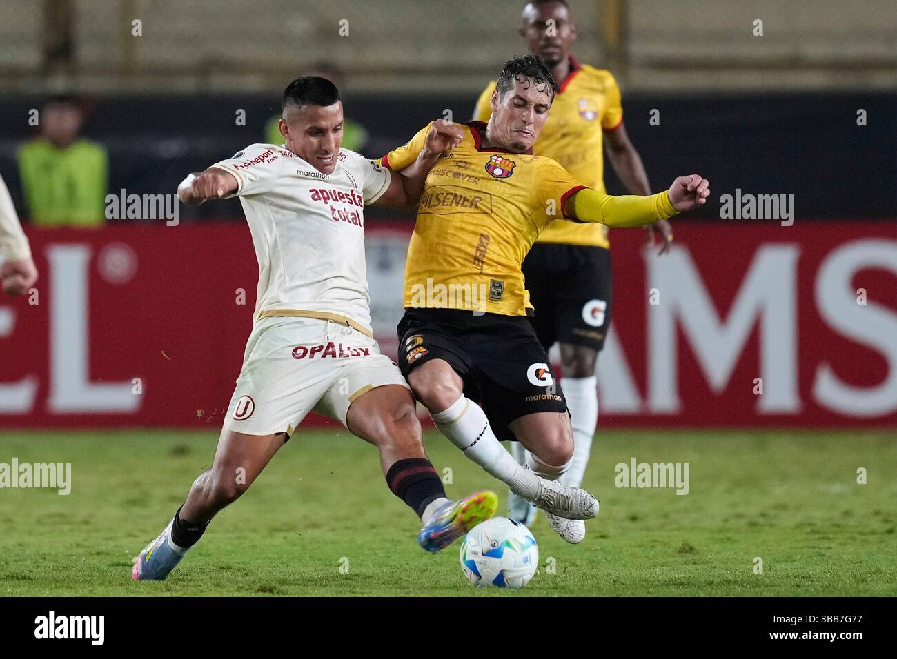 Alex Valera of Peru's Universitario de Deportes, left, and Raul Rivero ...
