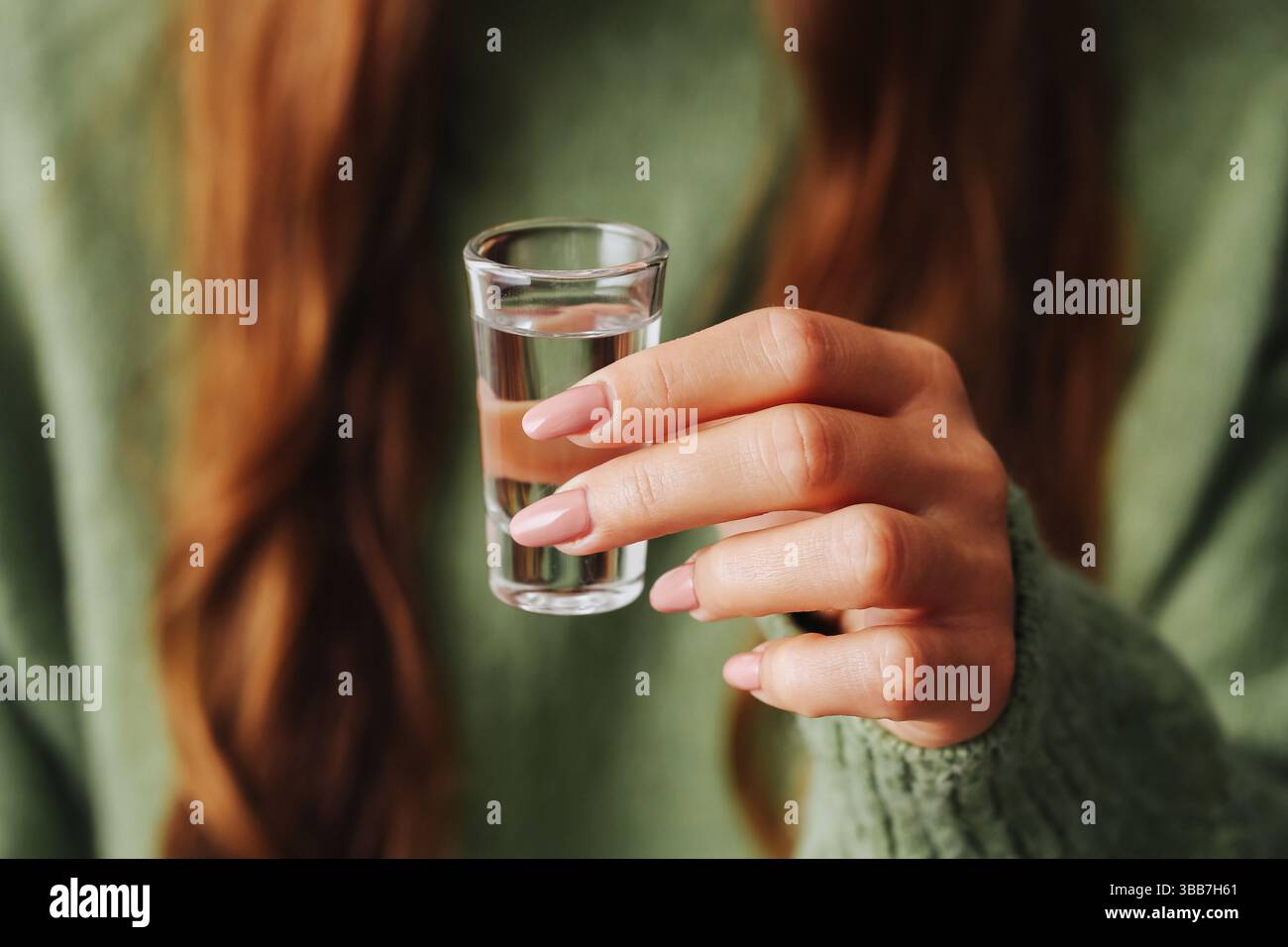 Woman holding shot glass. Alcohol addiction concept. Drinking problem ...