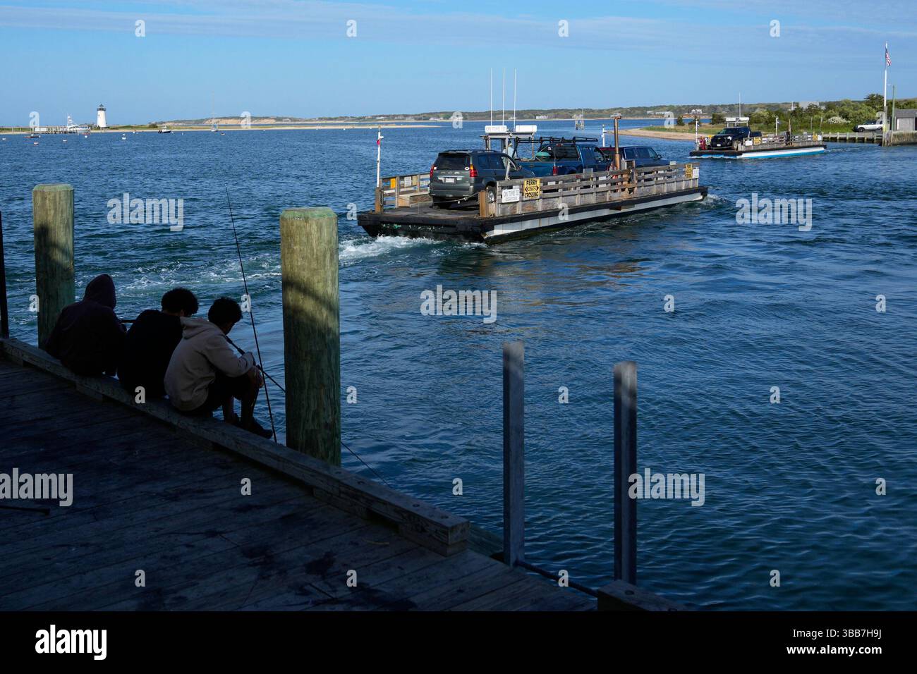 Young fishermen watch the Chappaquiddick ferries, Wednesday, May 14 ...