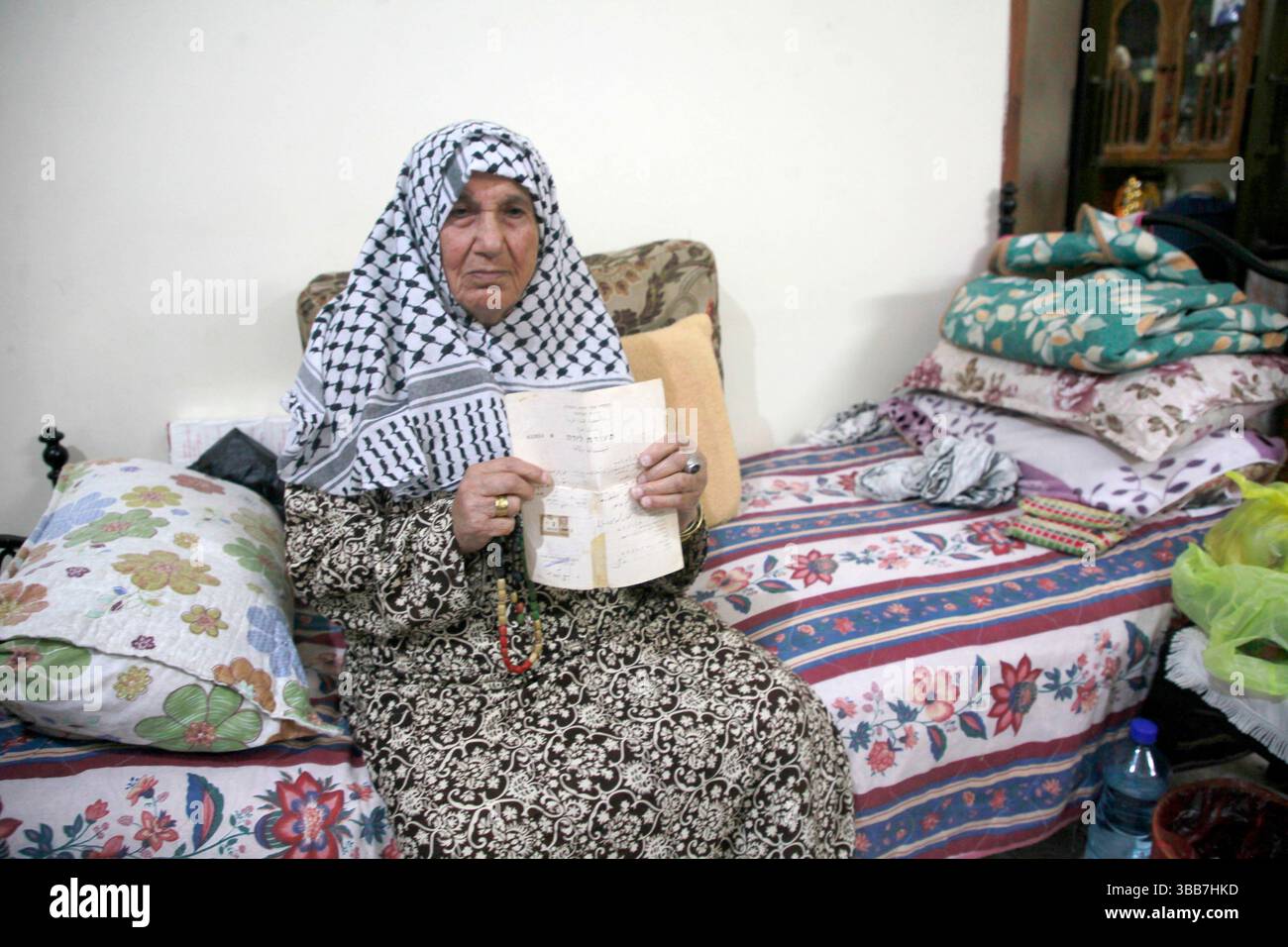 Palestinian refugee Zahdia Khadisha, 90 holds her birth certificate as ...
