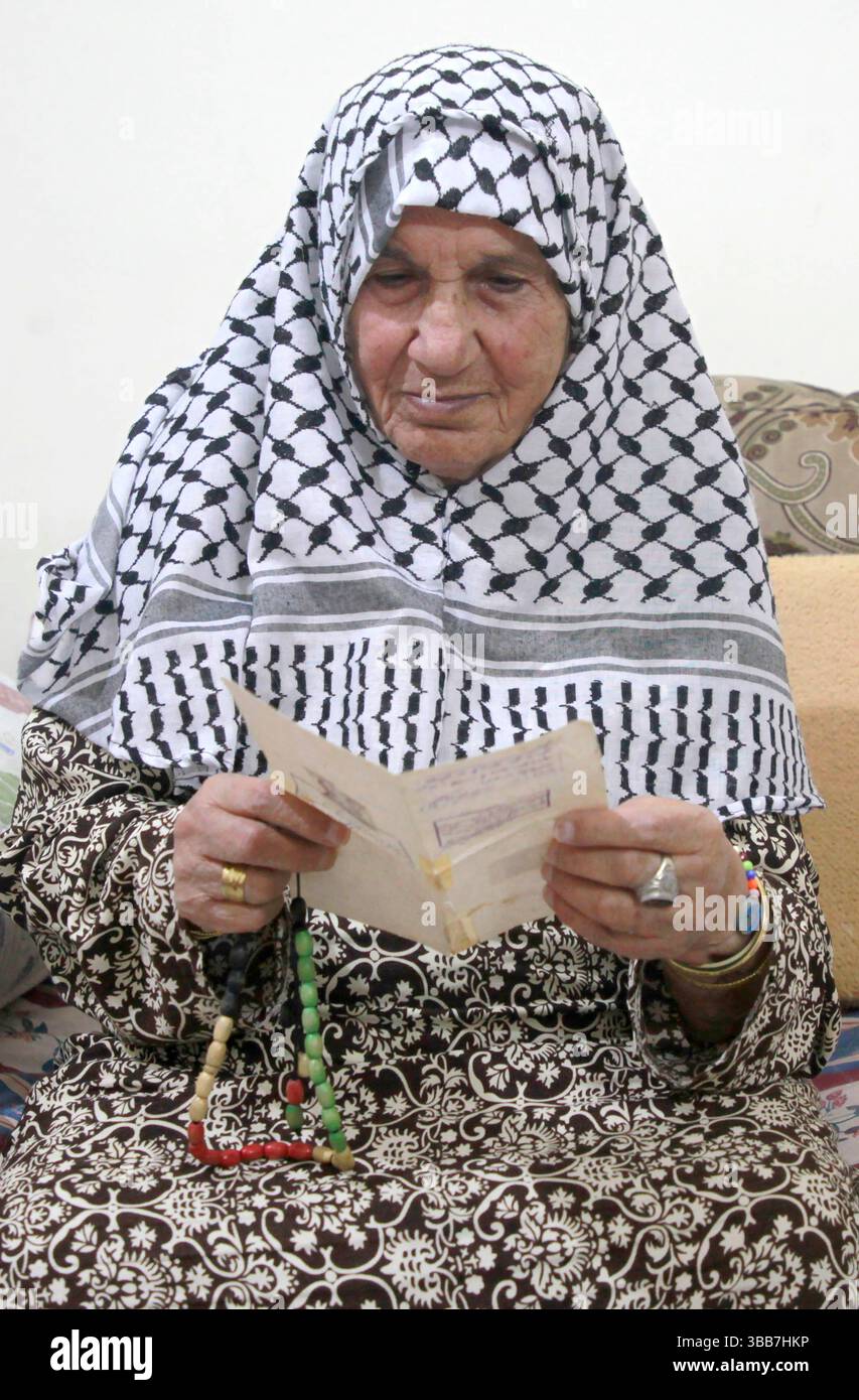 Palestinian refugee Zahdia Khadisha, 90 holds her birth certificate as ...