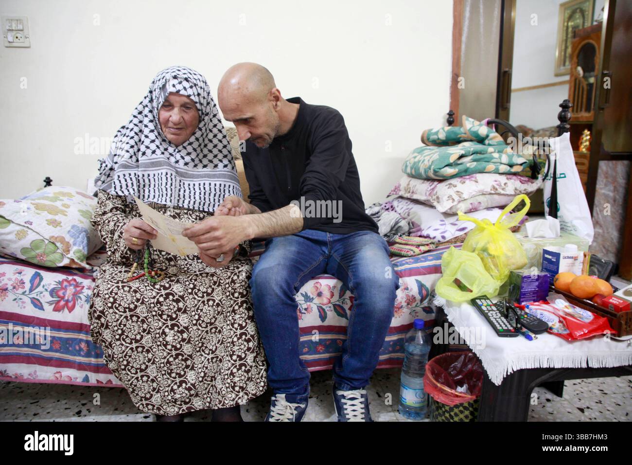 Palestinian refugee Zahdia Khadisha, 90 holds her birth certificate as ...
