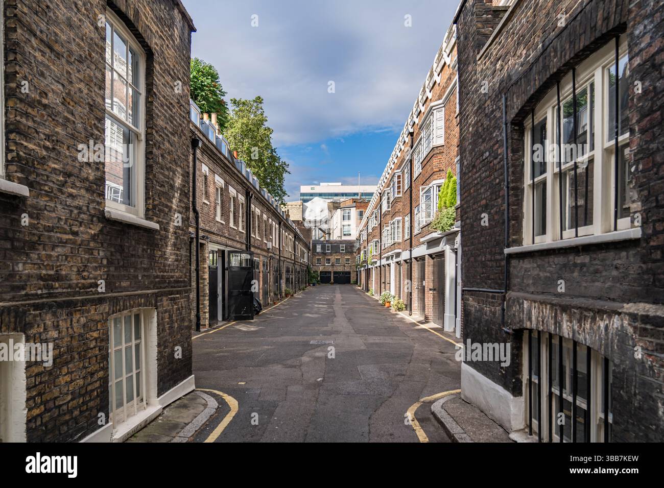 Narrow Alley Between Classic Brick Buildings Under Clear Sky, Featuring ...
