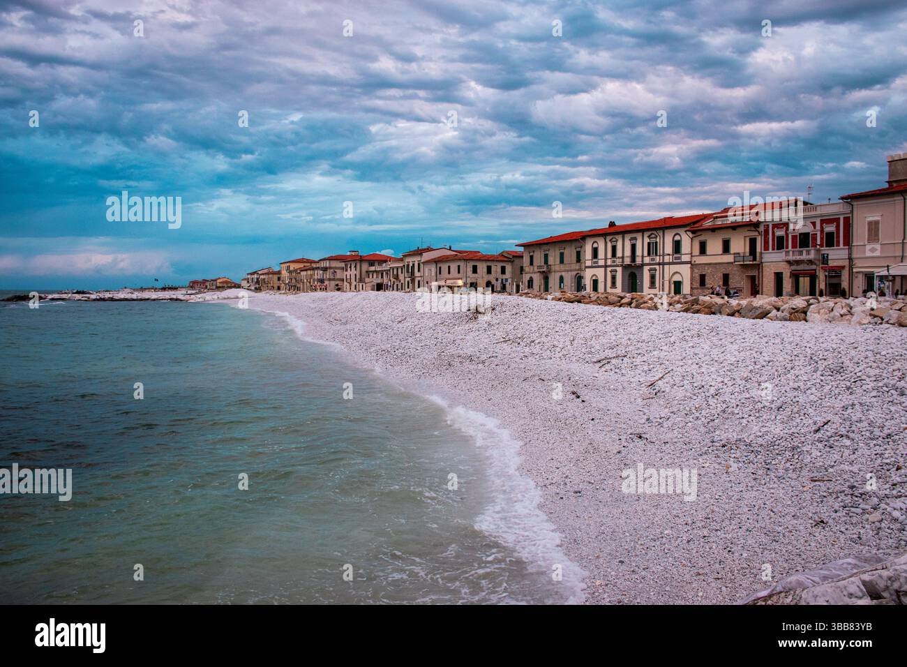 Spring view of the sea at Marina di Pisa under a cloudy sunset sky ...