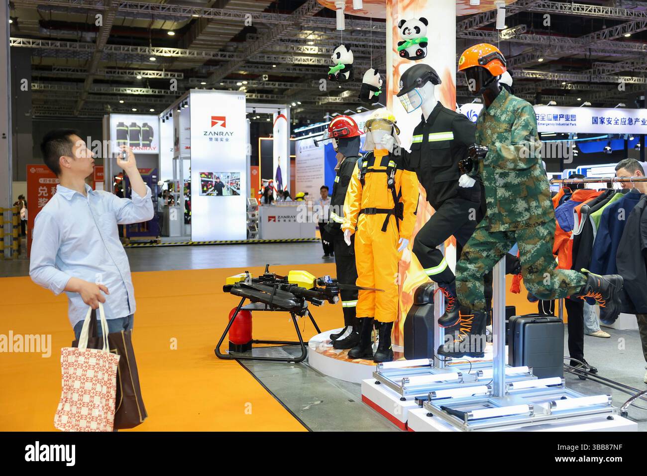 Shanghai, China. 13th May, 2025. A visitor takes photos of the fire ...