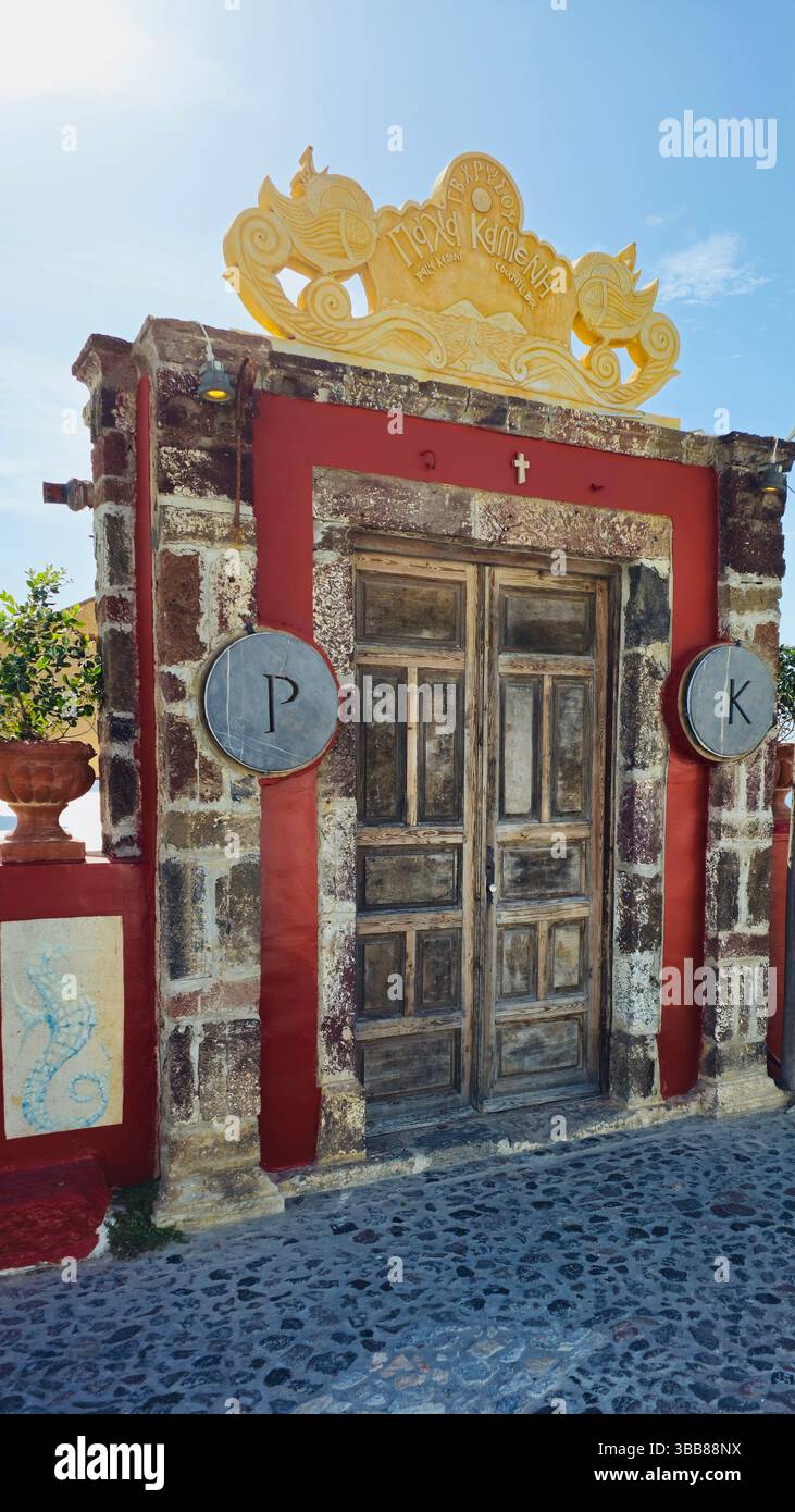 Fira, Santorini, May 5, 2025. Beautiful arched door with a sign of the ...