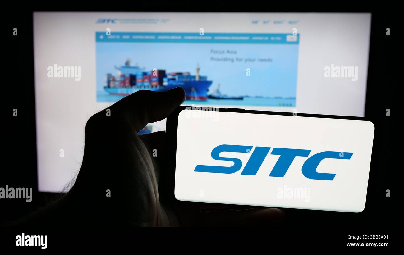 In this photo illustration, a person is holding a mobile phone with the ...