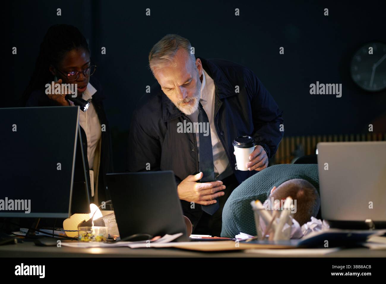 Police officers investigating crime scene examining evidence and victim ...