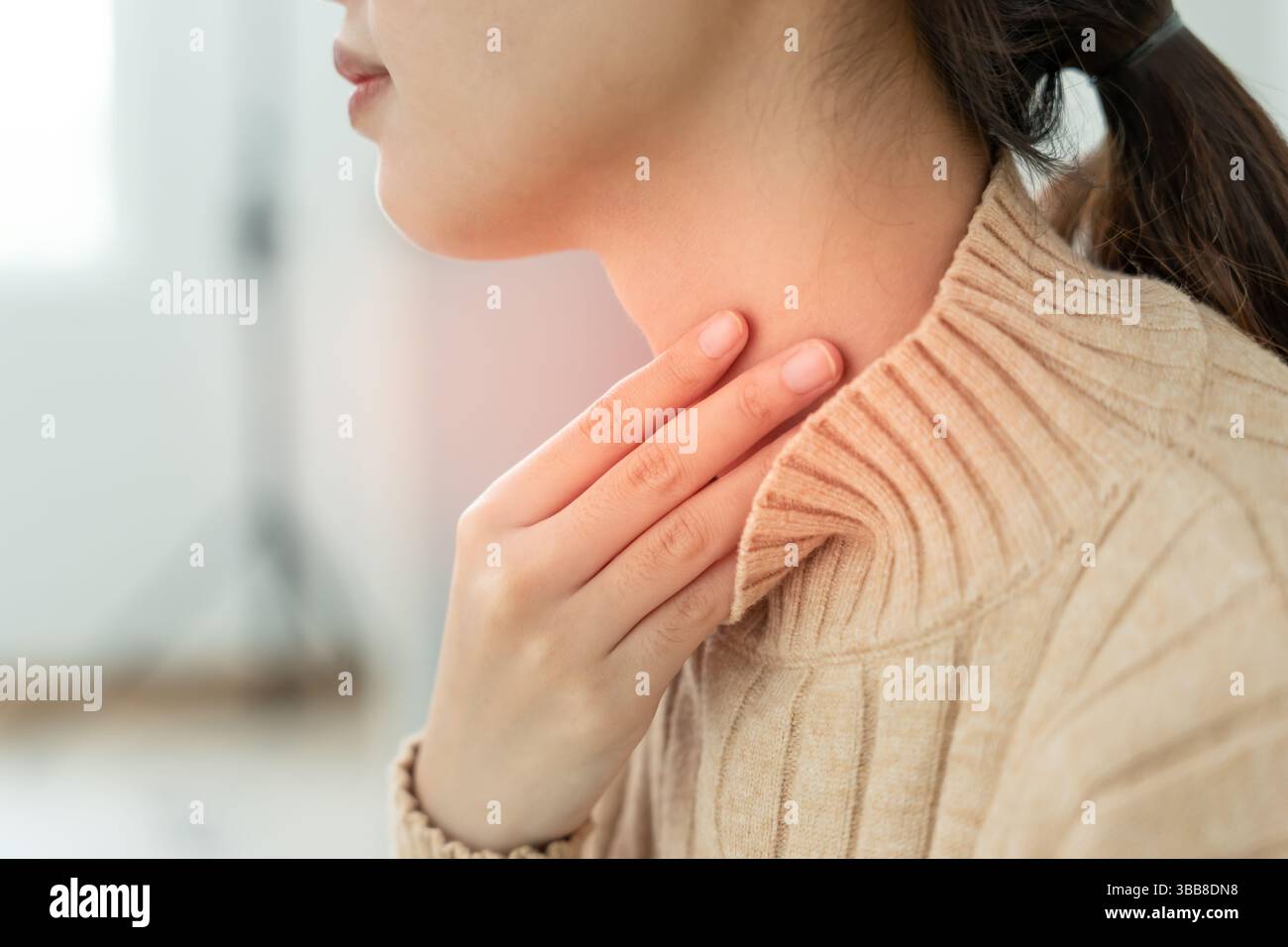 Asian woman put on neck due to a sore throat. female tonsillitis causes ...