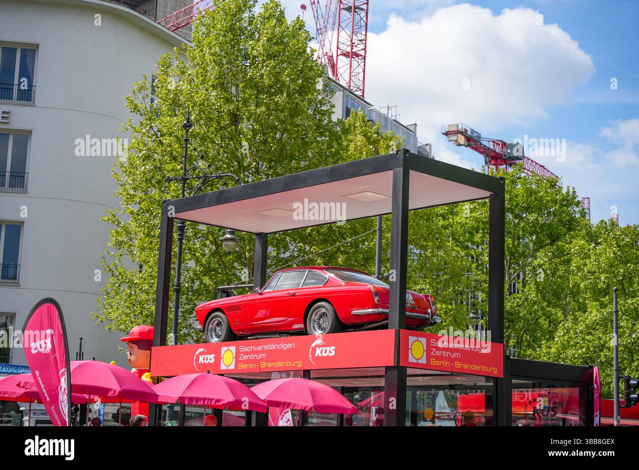 Germany Berlin May 11, 2025. Red classic car on an exhibition platform ...