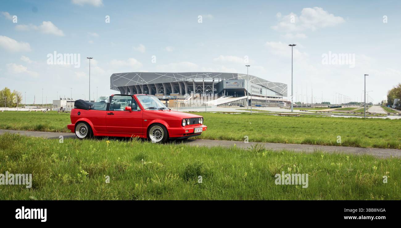 Red Volkswagen Golf mk2 cabriolet near Arena Lviv. Side view of 1990s ...