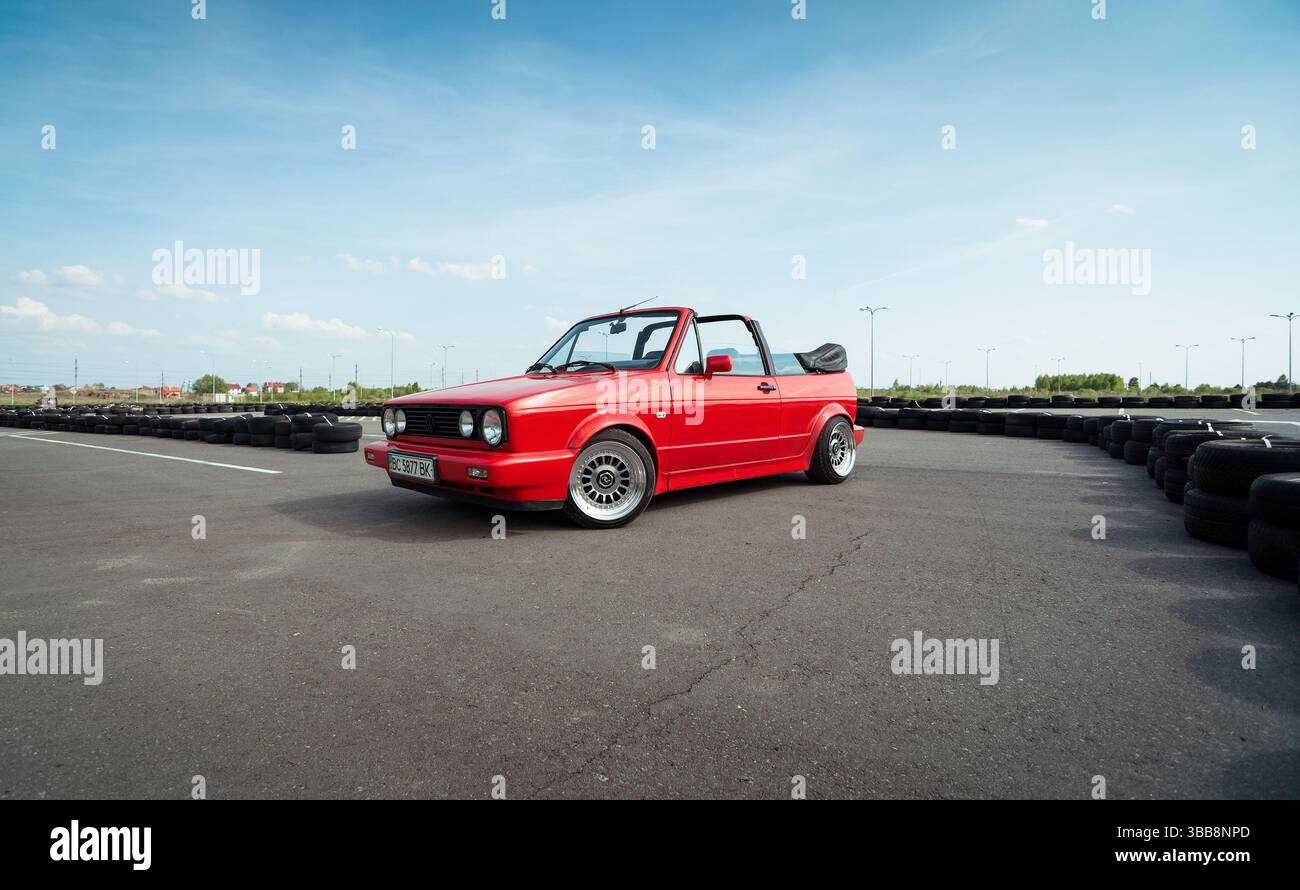 Red Volkswagen Golf mk2 cabriolet on kart circuit. Three quarter front ...