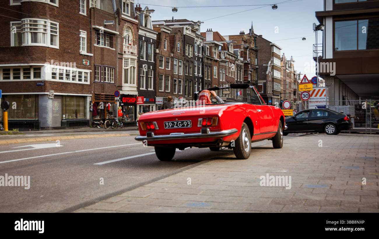 Red Peugeot 504 parked on a street in Amsterdam. Rear three quarter ...