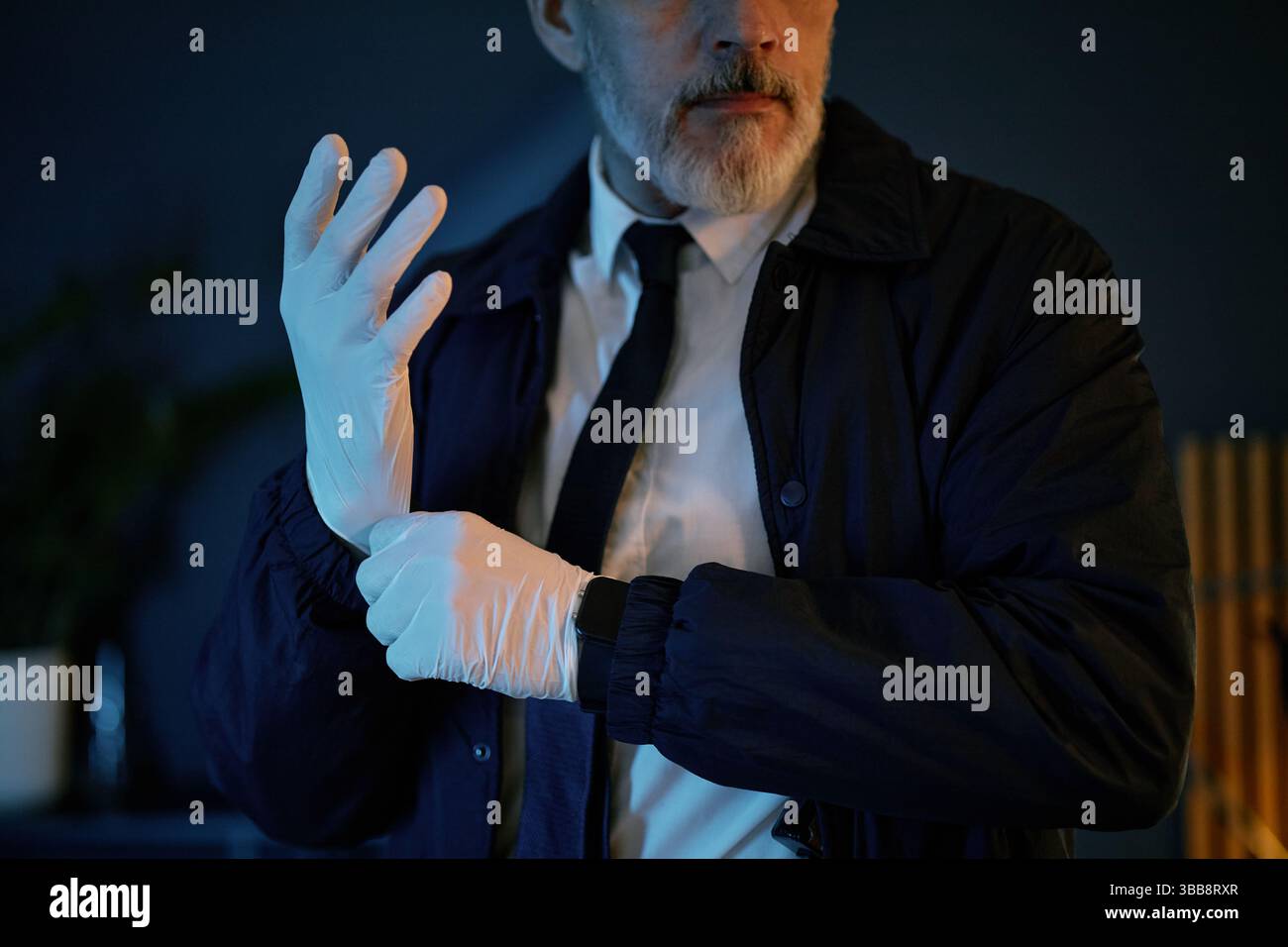 Person adjusting white latex glove while dressed in a formal black ...