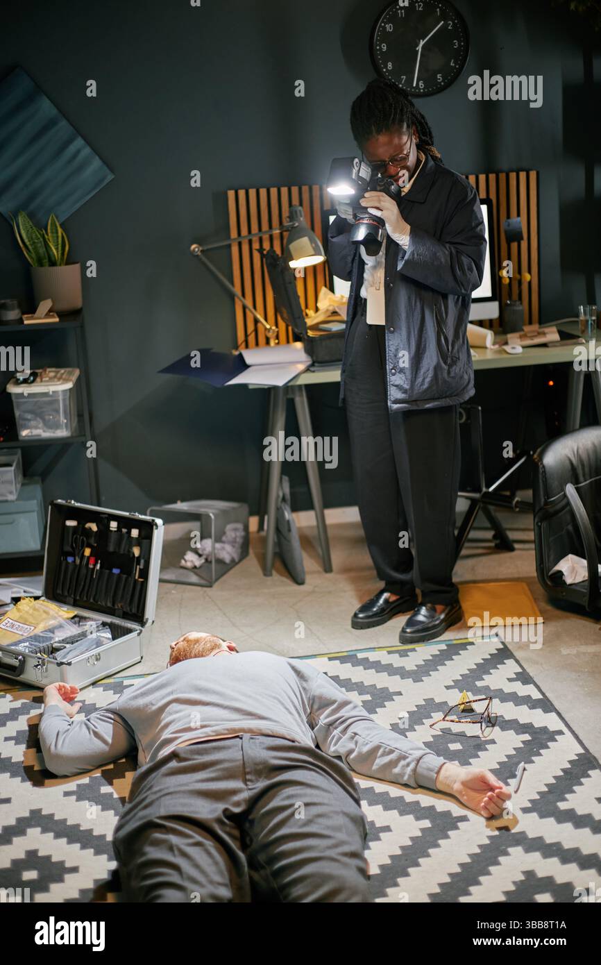 Investigator capturing evidence at crime scene with forensic tools ...