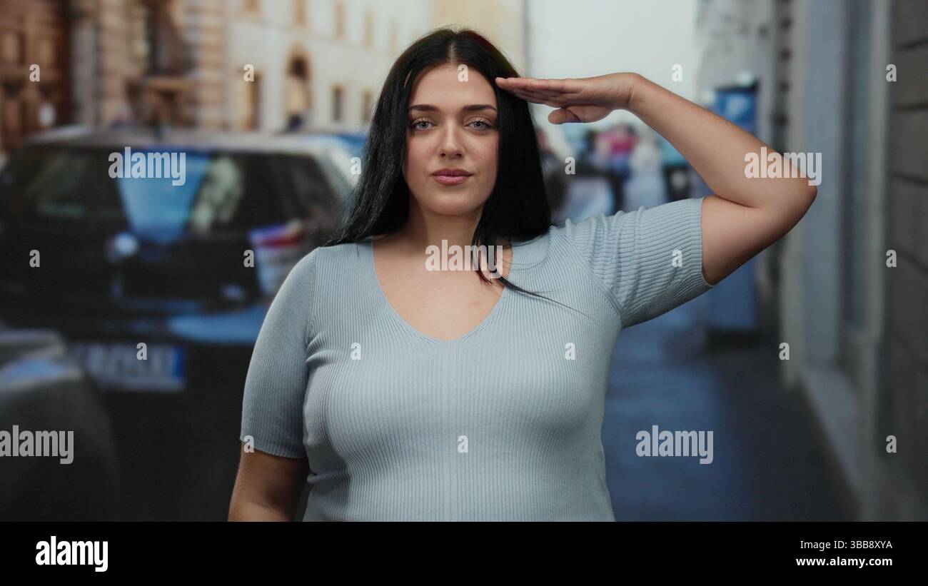 Woman saluting in bustling outdoor hi-res stock photography and images ...