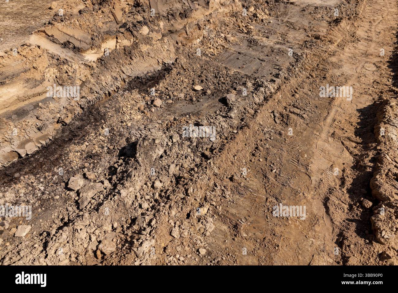 excavated pits during construction work on the road, cloudy weather at ...