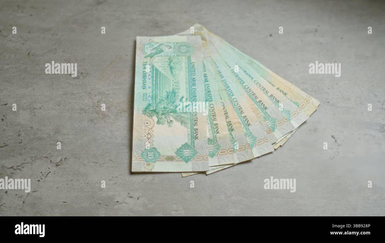 United arab emirates banknotes of different denominations spread on a ...