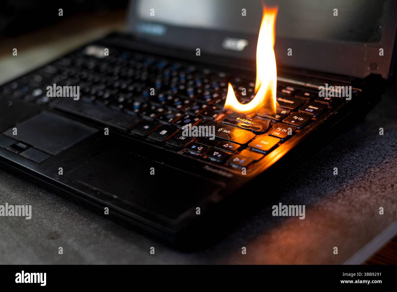 The computer laptop is burning with flames Stock Photo - Alamy