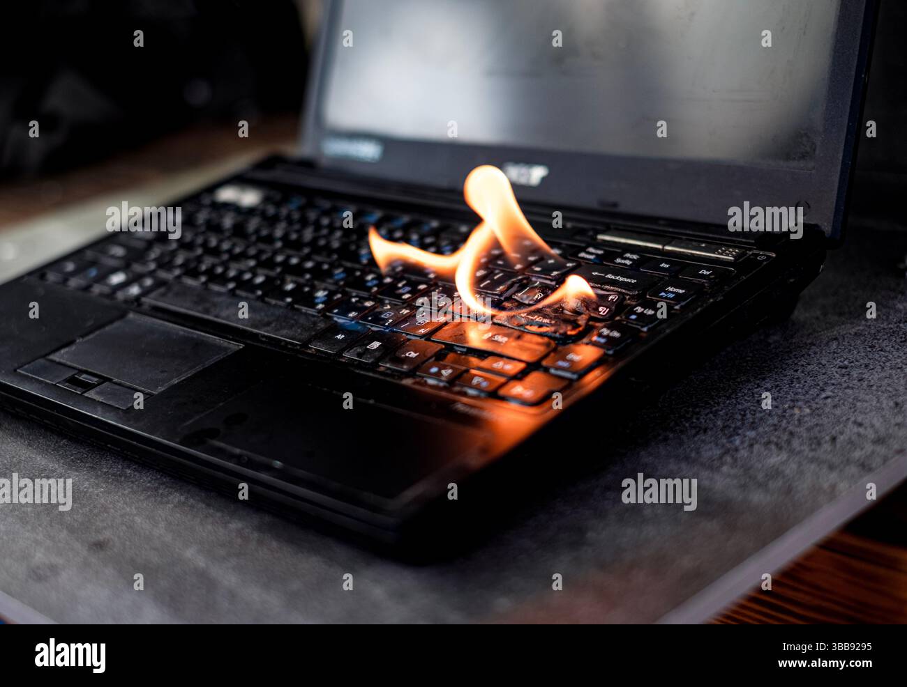 The computer laptop is burning with flames Stock Photo - Alamy
