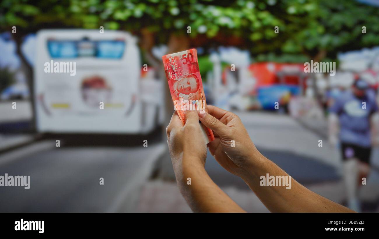 Man holding philippine pesos outdoors hi-res stock photography and ...