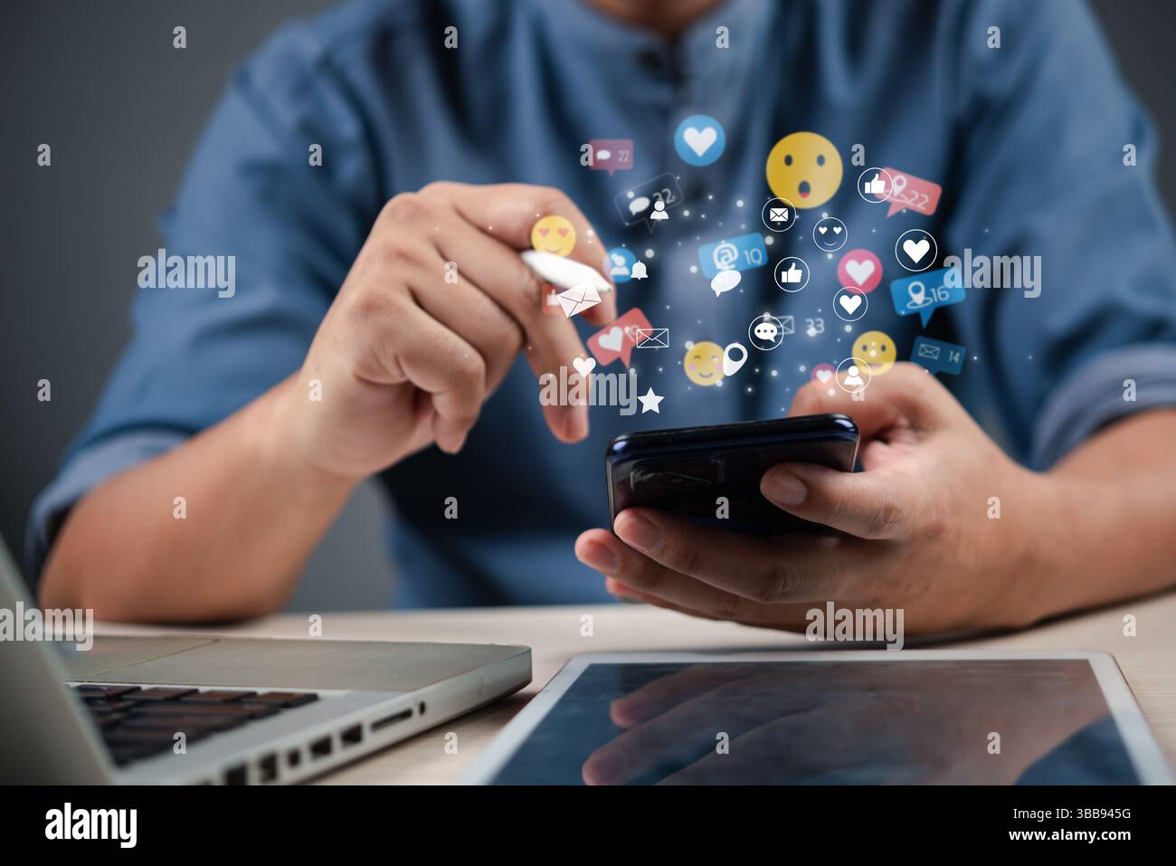 businessman using a smartphone with social media icons floating around ...