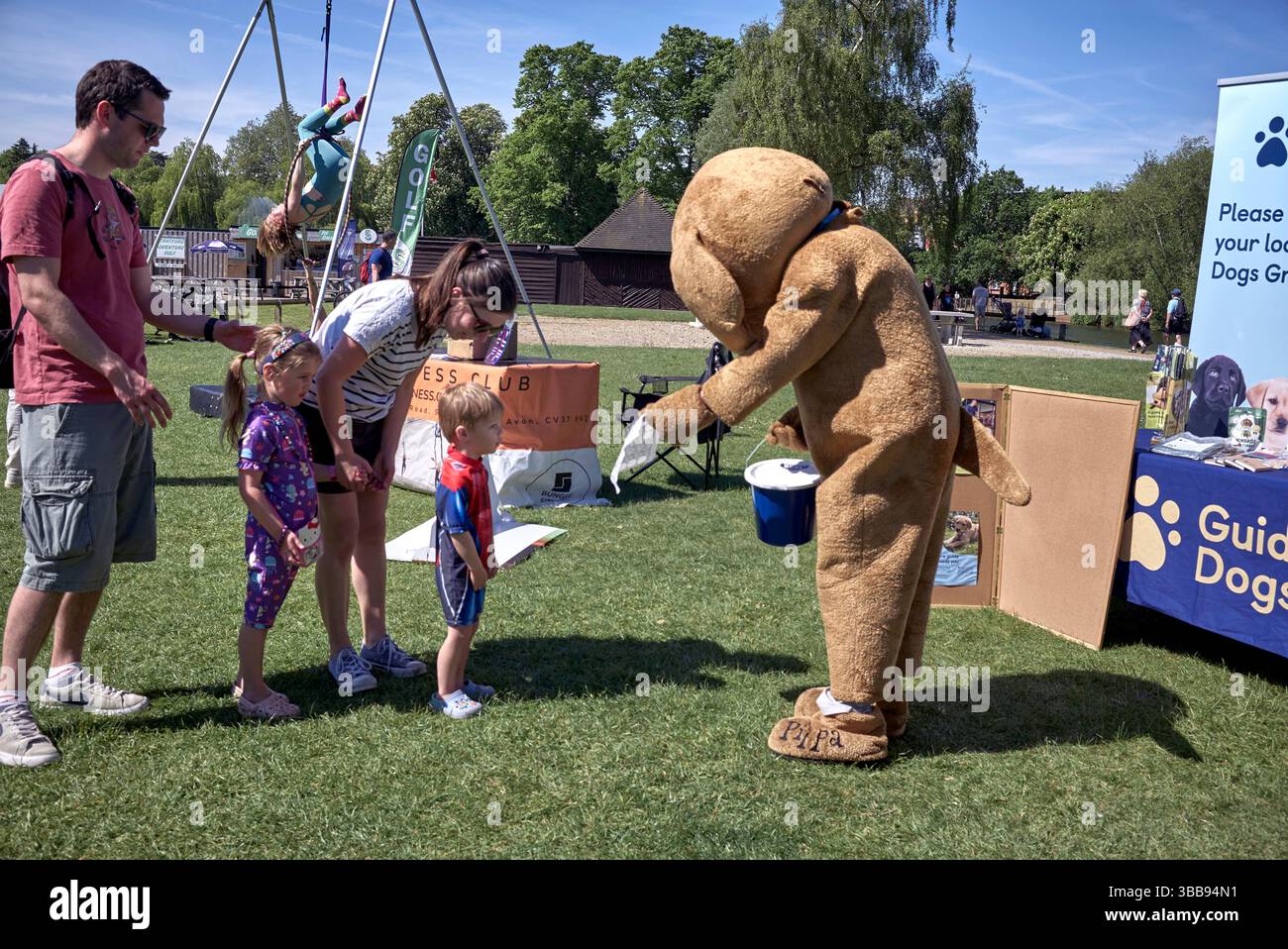 Person dressed in a dog costume collecting donations for the guide dogs ...