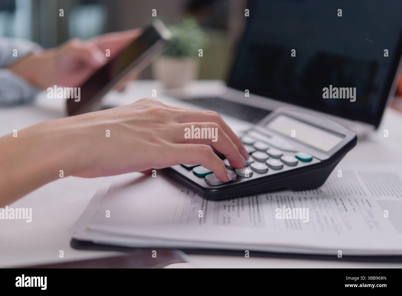 Office worker performing calculations hi-res stock photography and ...