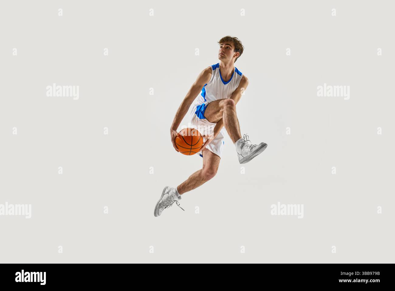 Young athletic man, basketball player soaring upward with dynamic ...