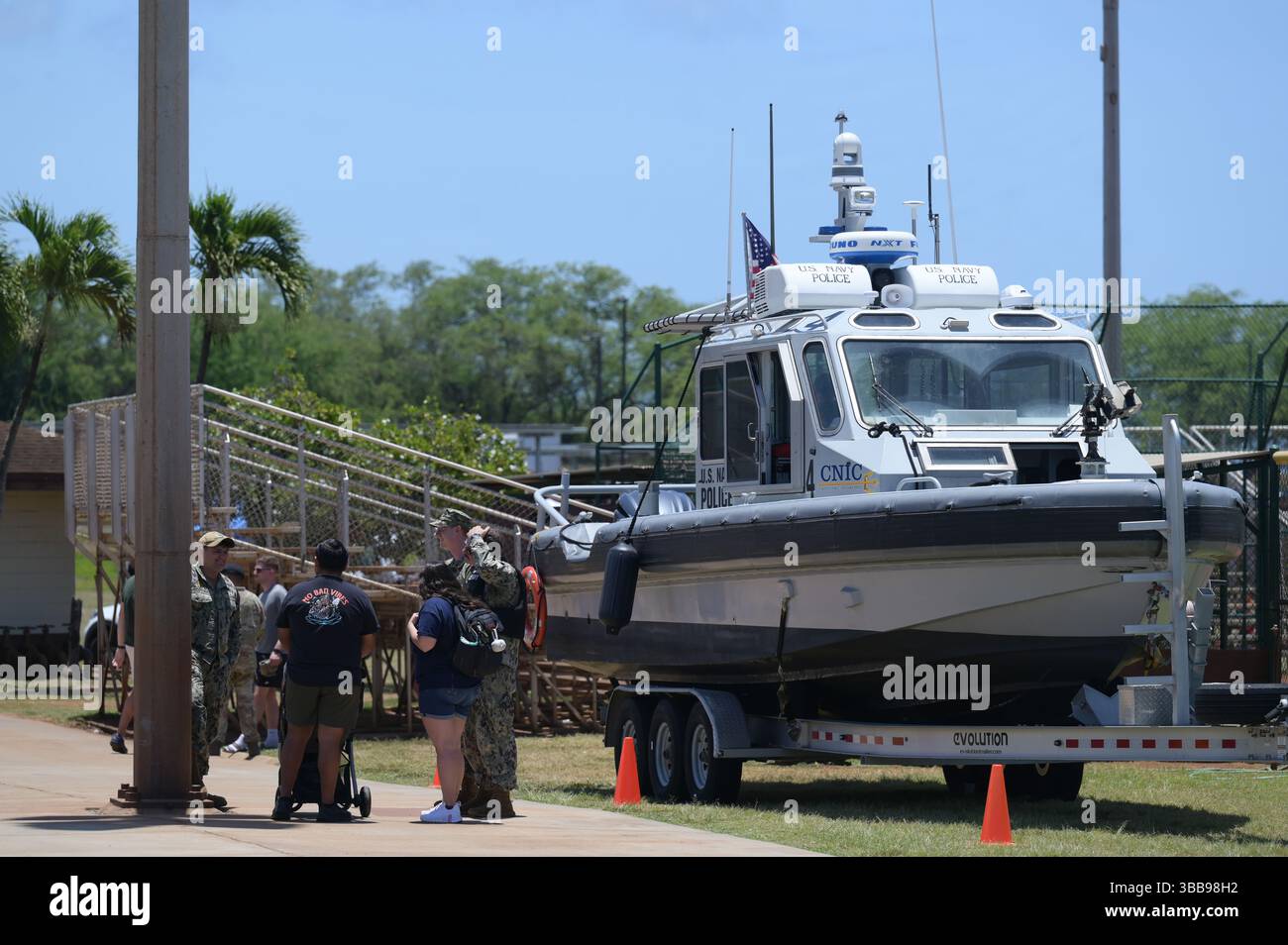 U.S. Navy Sailors assigned to Joint Base Security display a harbor boat ...