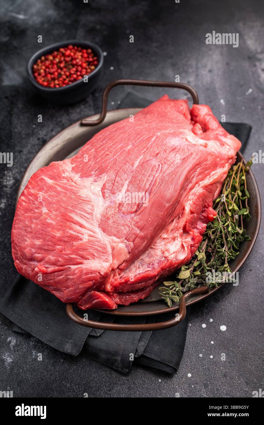 Raw Top Round beef meat cut, topside with hrebs for roast. black ...