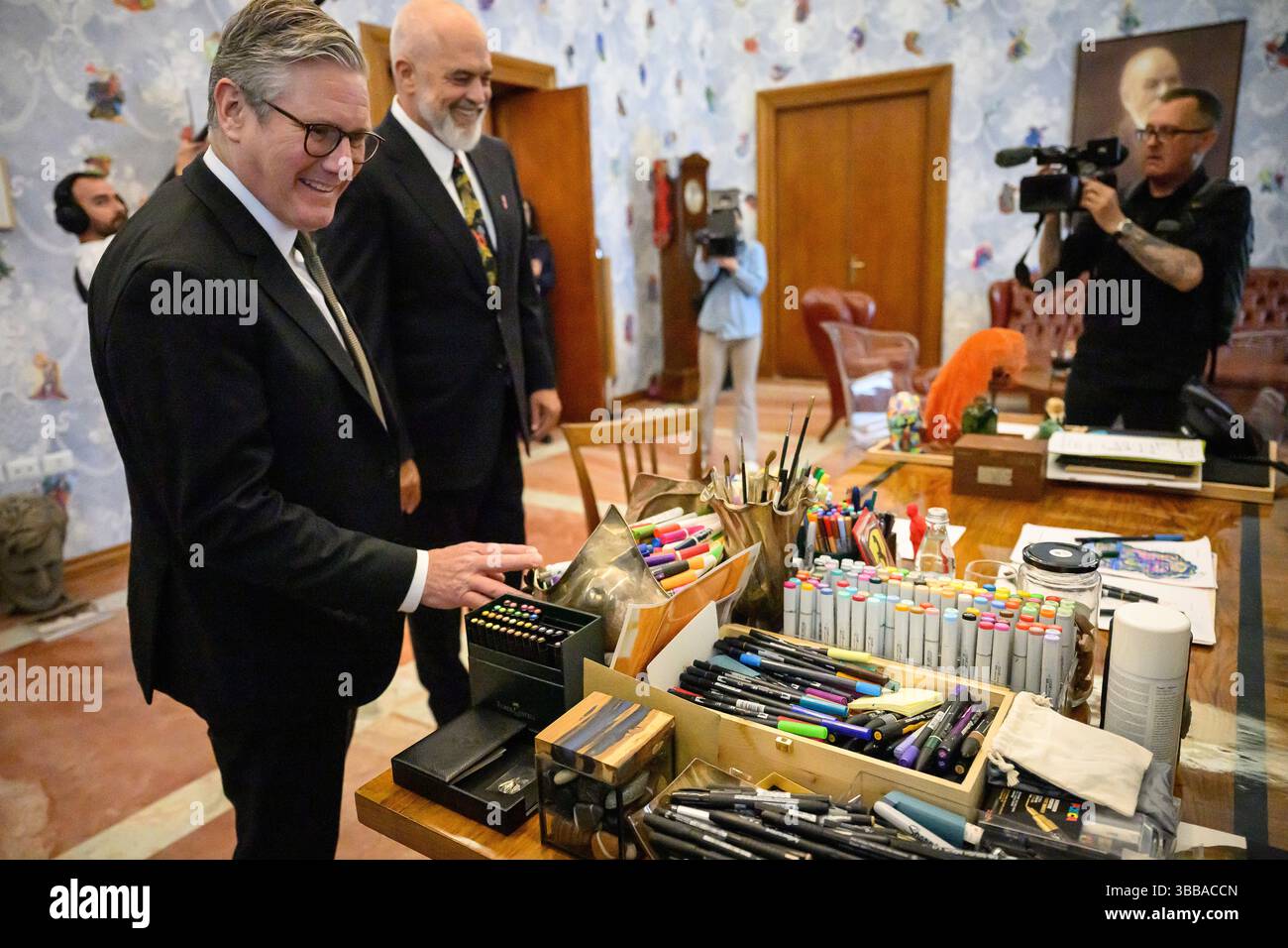 Britain's Prime Minister Keir Starmer, left, looks at the desk of ...