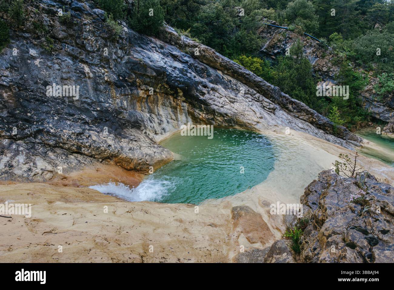 Emerald natural pools in rocky river canyon. Crystal clear water ...