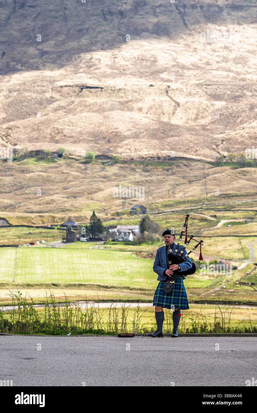 Bagpiper over Loch Tulla and River Orchy from a drone, Highlands ...