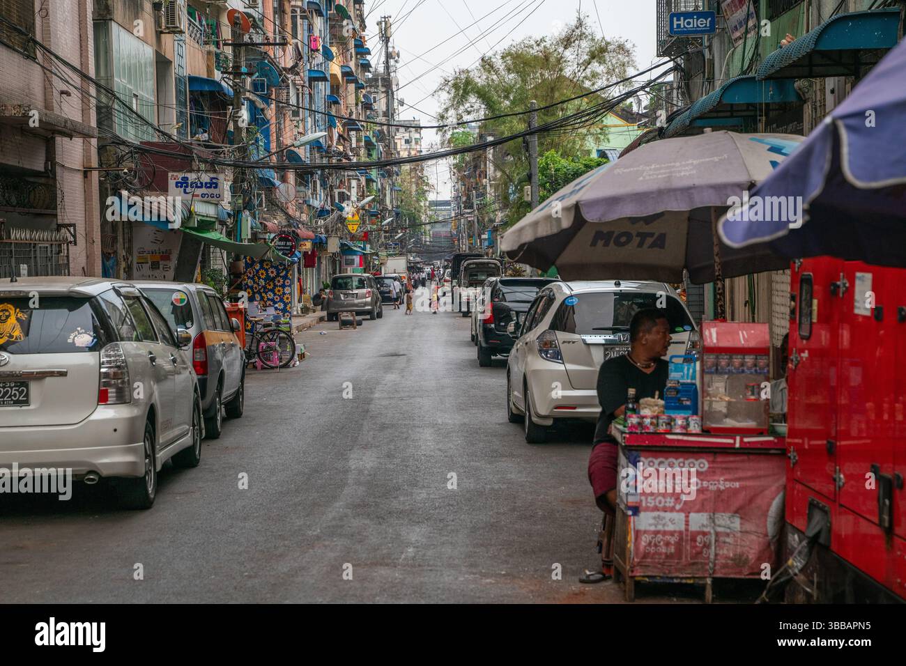 Yangon, Myanmar - 6 April, 2025: A typical street scene showing daily life and local activity in ...