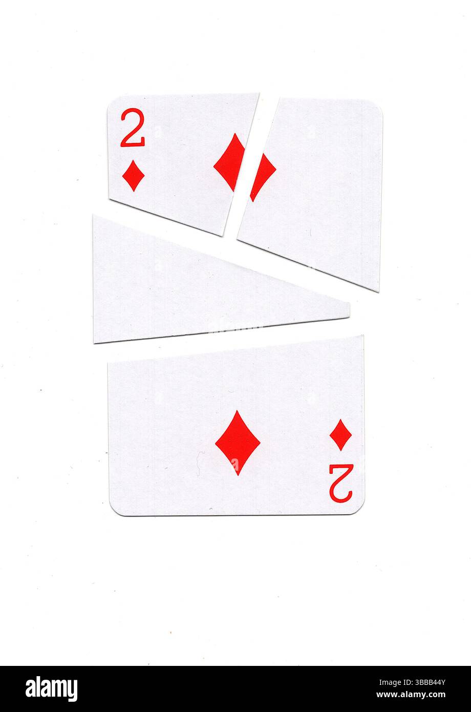 A vintage playing card cut into sharp pieces on a white background ...