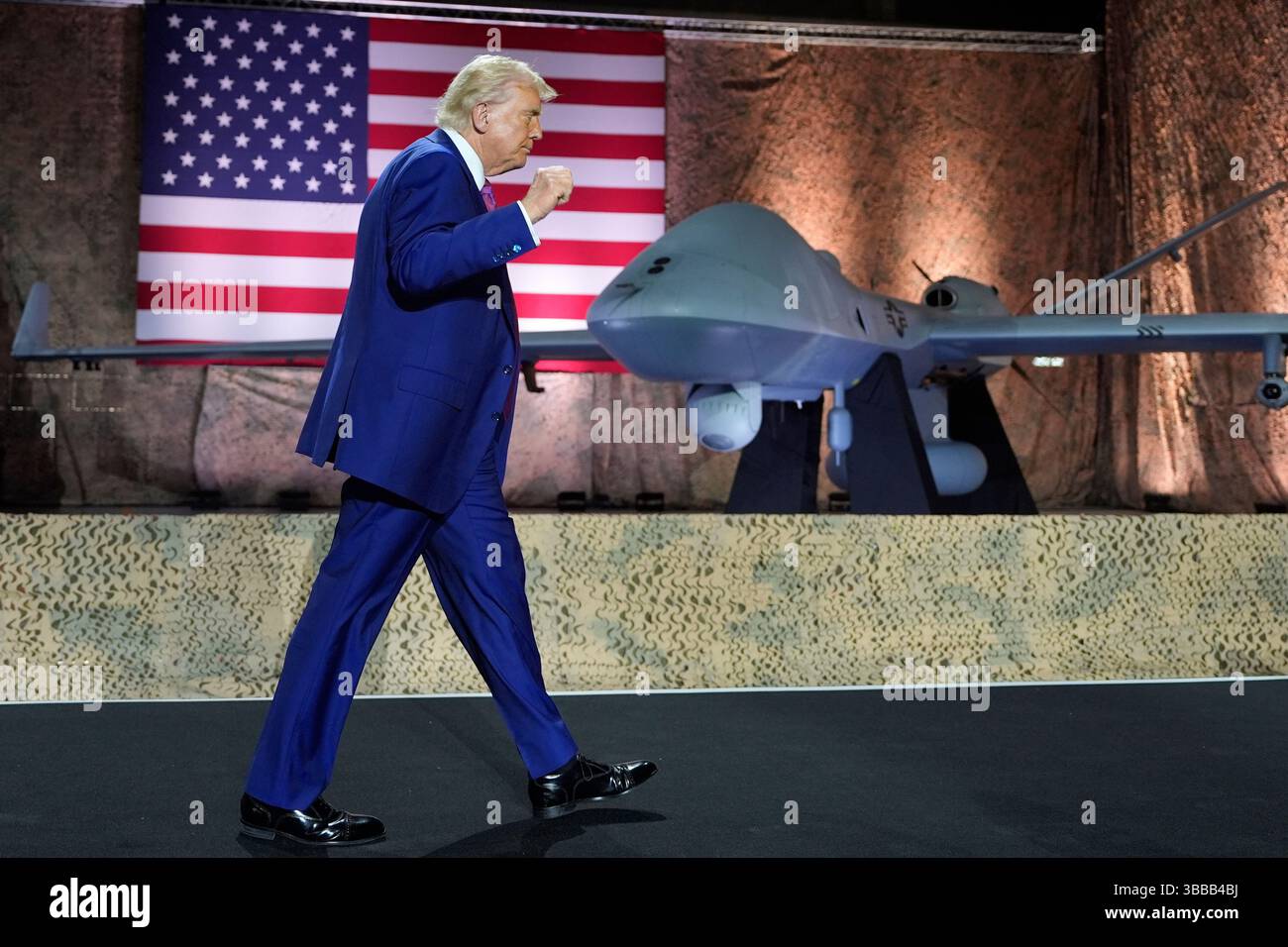 President Donald Trump gestures on stage at the Al Udeid Air Base, Thursday, May 15, 2025, in ...