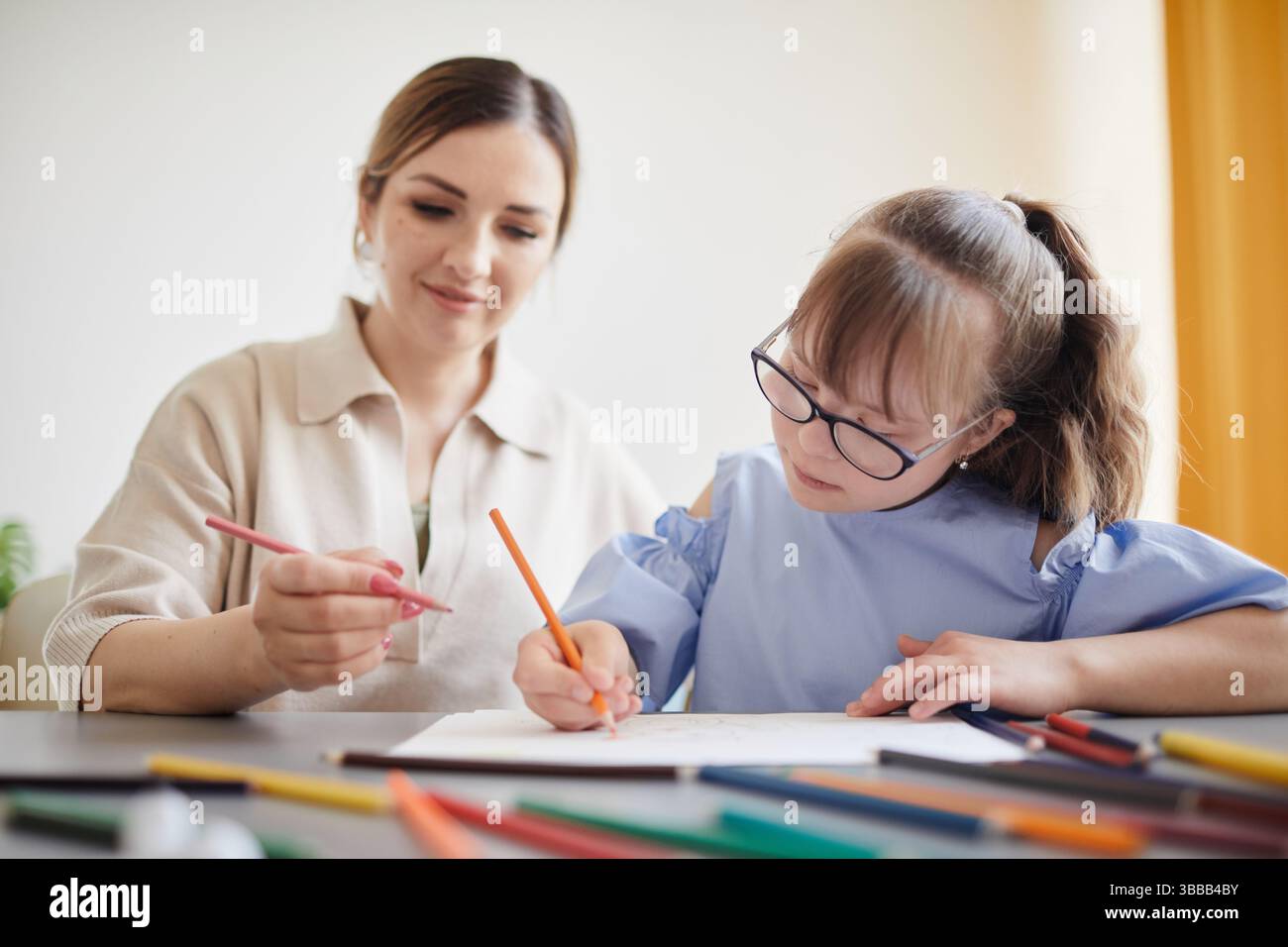 Girl with Down Syndrome Drawing Pictures Stock Photo - Alamy