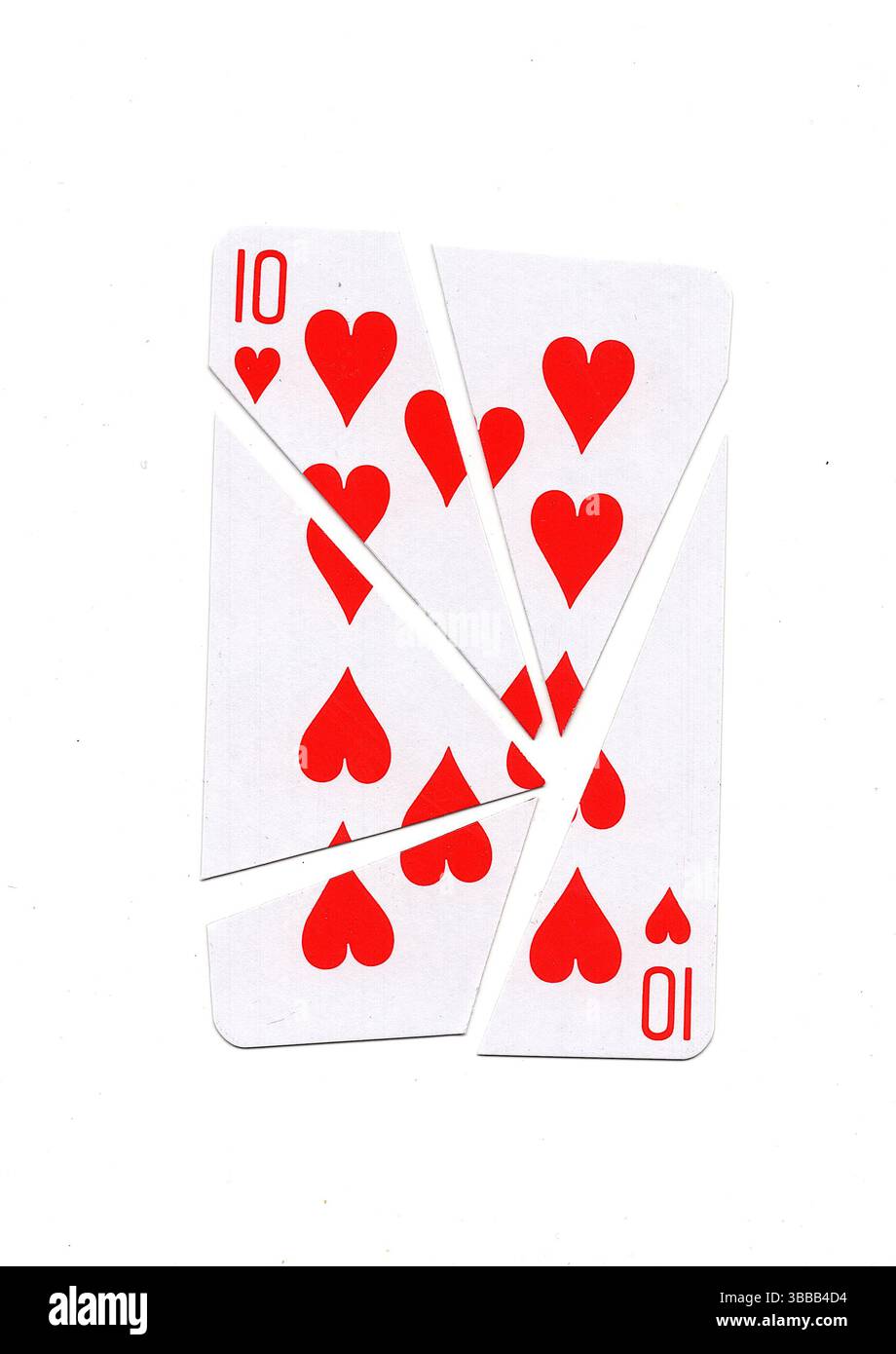 A vintage playing card cut into sharp pieces on a white background ...