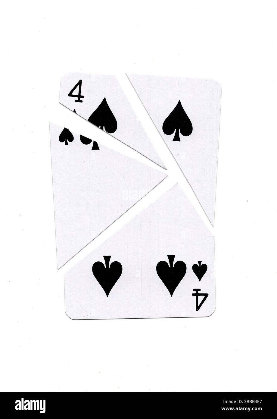 A vintage playing card cut into sharp pieces on a white background ...