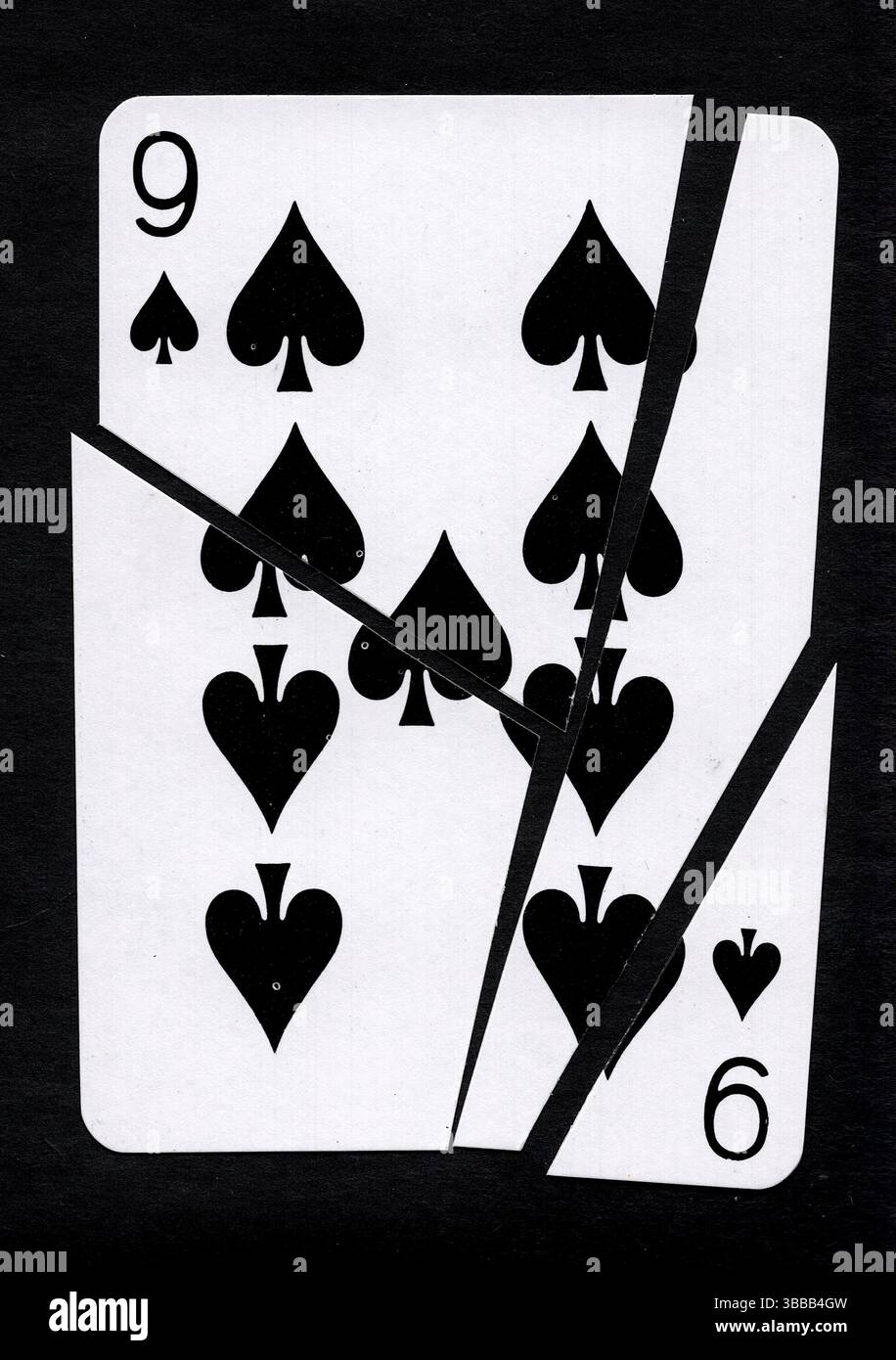 A vintage playing card cut into sharp pieces isolated on a black ...