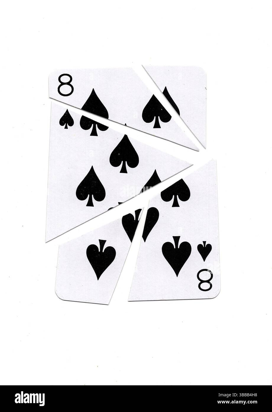 A vintage playing card cut into sharp pieces on a white background ...