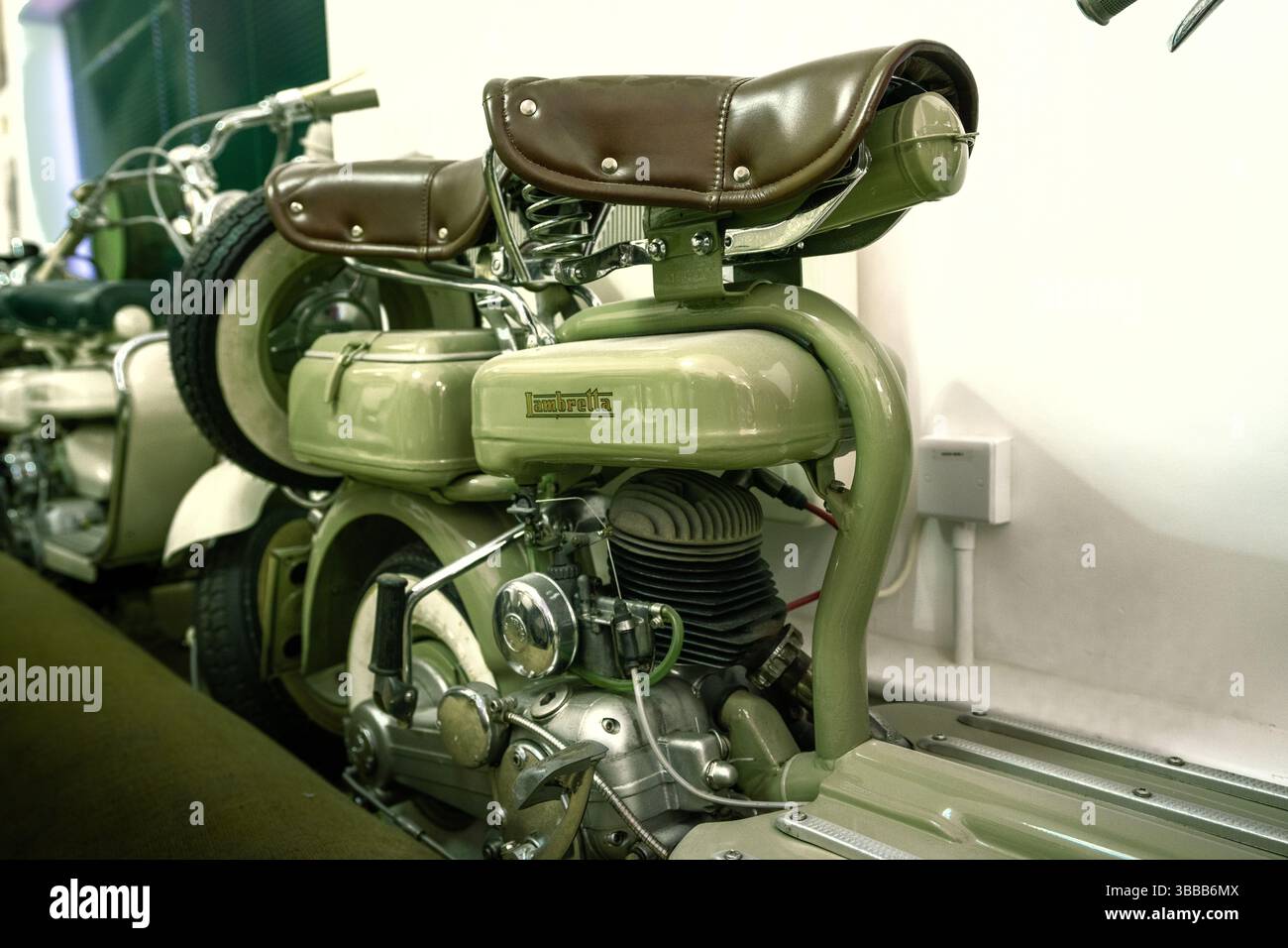Very old Model A lambretta scooter in pale green with brown leather ...